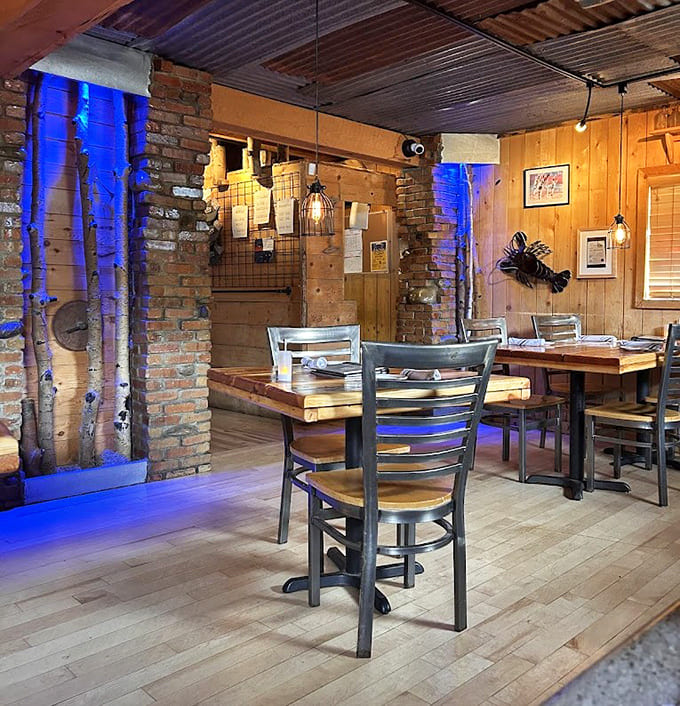 Exposed brick columns bathed in blue light stand as reminders of the building's authentic mining-era heritage.