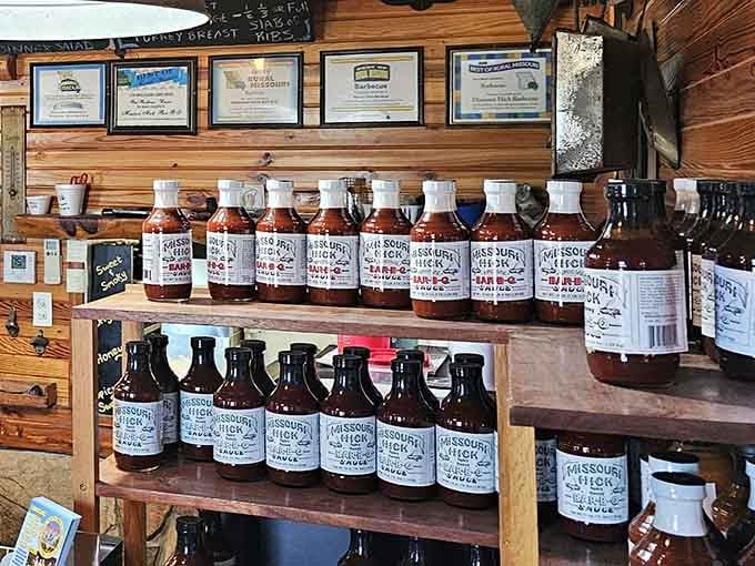 Bottled barbecue sauce lined up like trophies, ready to take the flavor home with you.