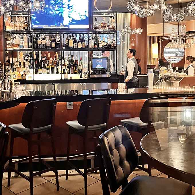 A well-stocked bar with sparkling glassware overhead is where the evening begins and sometimes where it ends, too.