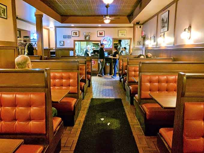 Rows of booths filled with eager diners create an atmosphere that's pure New Haven pizza culture.