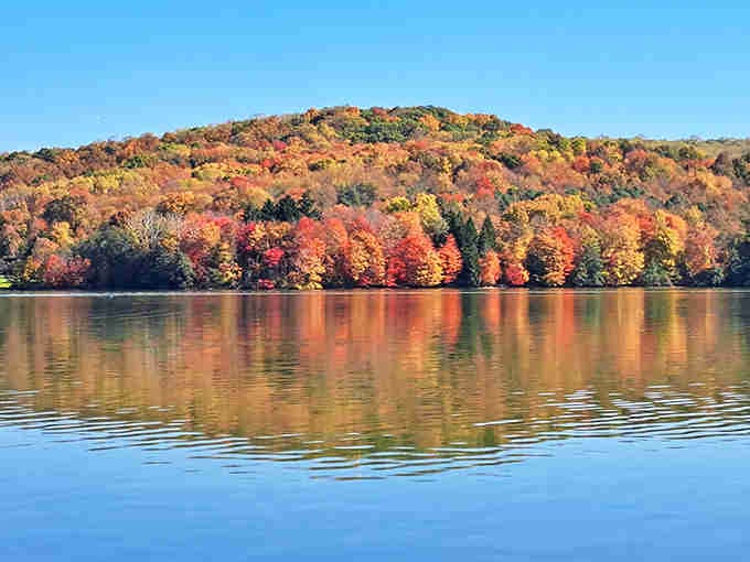Fall foliage reflects in still water, doubling your visual pleasure without charging admission twice.