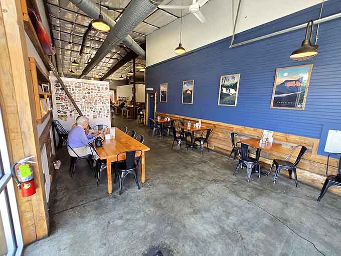 Blue walls and vintage posters create a dining space that feels both retro and refreshingly current somehow.