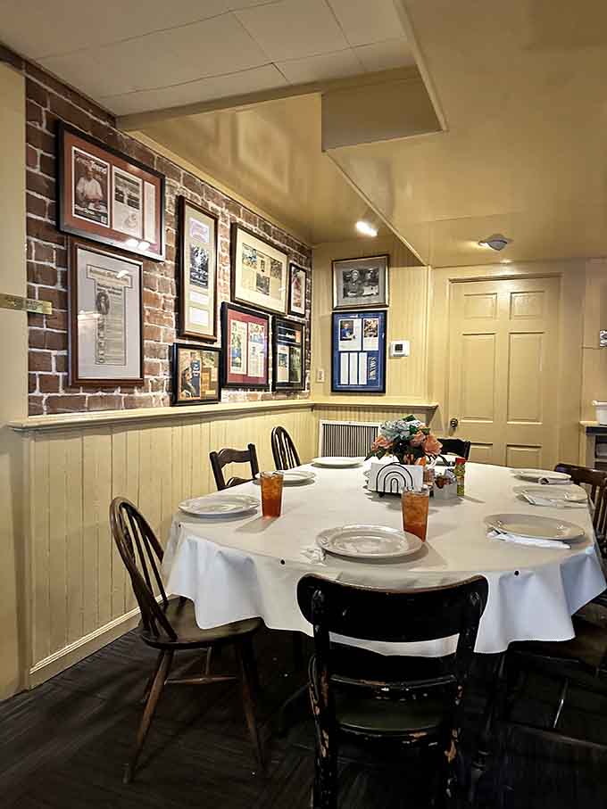 Exposed brick walls lined with framed memories create an atmosphere that feels more like dining history than just eating lunch.