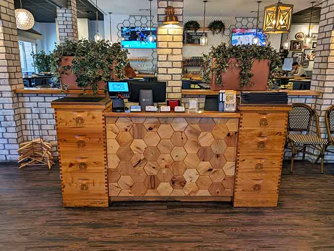 The order counter showcases that beautiful honeycomb design, where breakfast dreams officially become delicious reality.