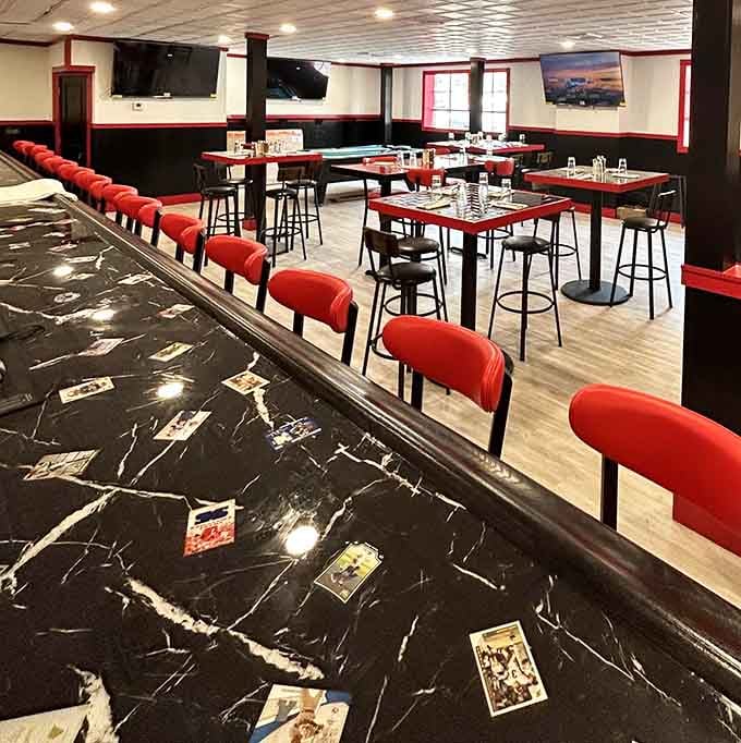 Red stools line up like soldiers ready to serve your pizza-eating mission with proper seating support.