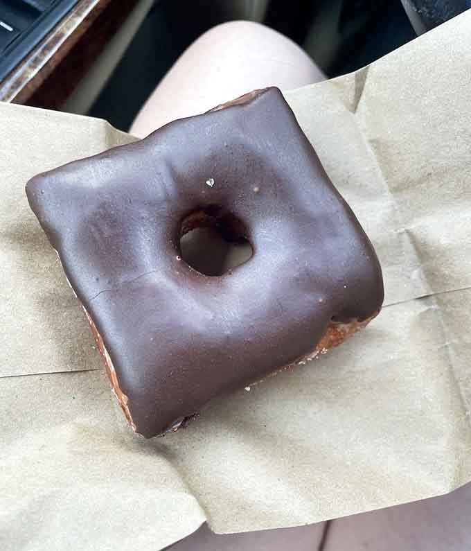 Simple chocolate icing on a perfectly square donut proves geometry can be absolutely delicious when done right.