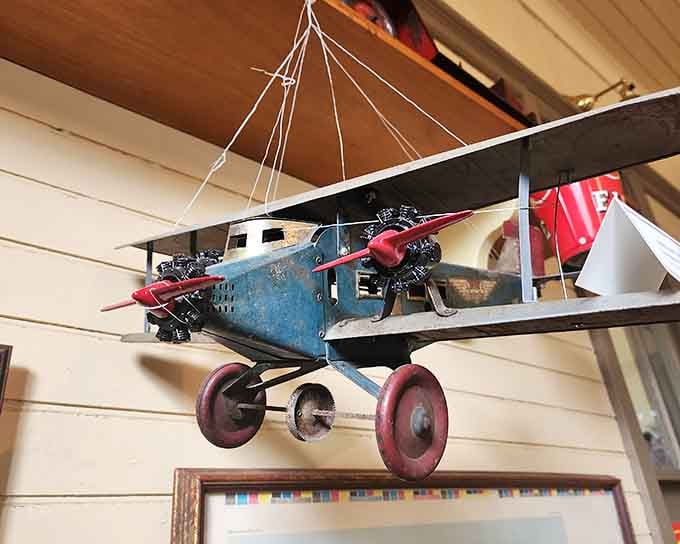 Suspended vintage aircraft models capture the magic of flight through a child's eyes, propellers frozen mid-adventure in time.