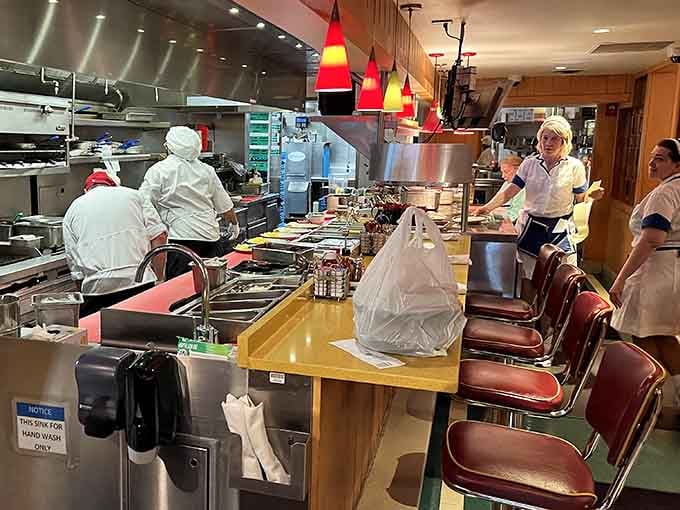 Counter seating offers front row seats to the culinary theater where breakfast dreams become delicious reality.