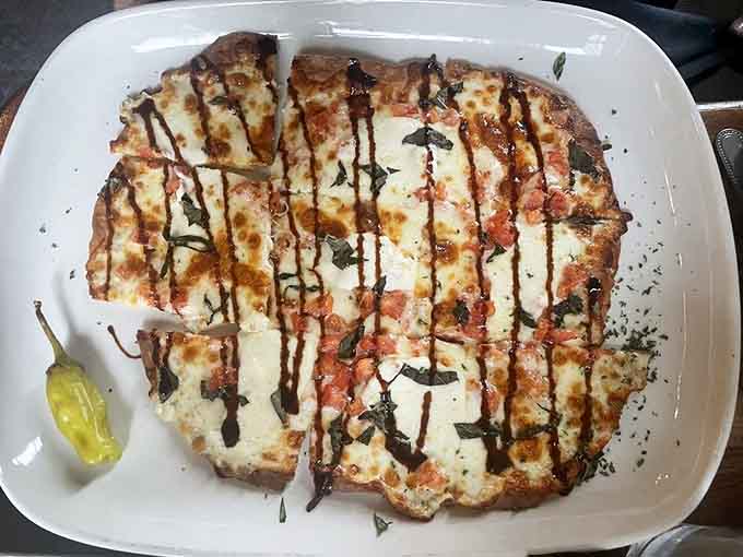 This flatbread brings Italian flavors to Illinois in the most delightful way possible, drizzled with balsamic perfection.