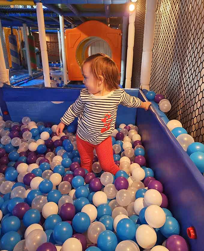 This ball pit invites toddlers to wade through an ocean of colorful spheres like tiny explorers.