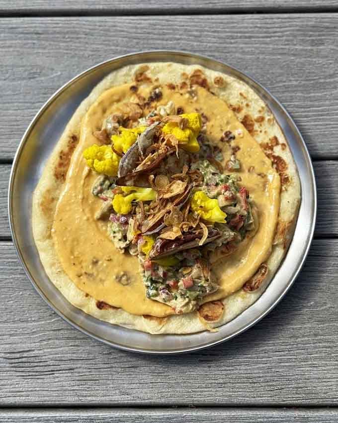 This curry chicken situation brings serious flavor complexity wrapped up in a tortilla that's barely holding on.