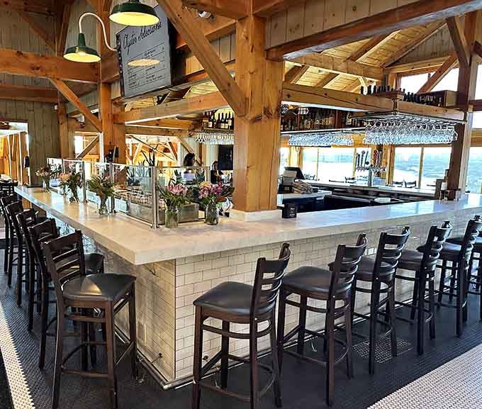 A bar that stretches invitingly beneath those timber beams, ready to pour whatever pairs with your seafood craving.