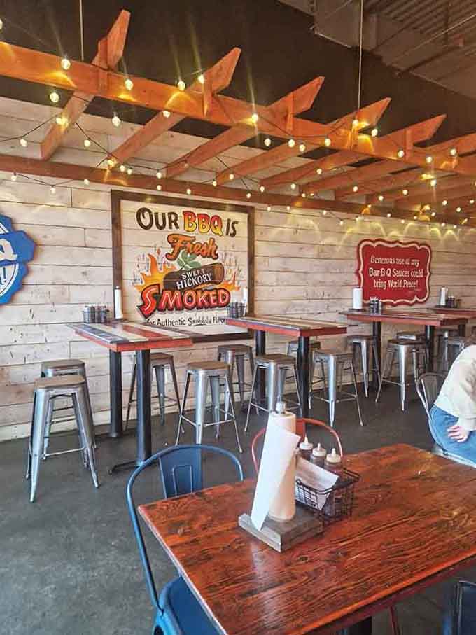 High-top tables under twinkling lights where strangers become friends over shared love of smoked meats.