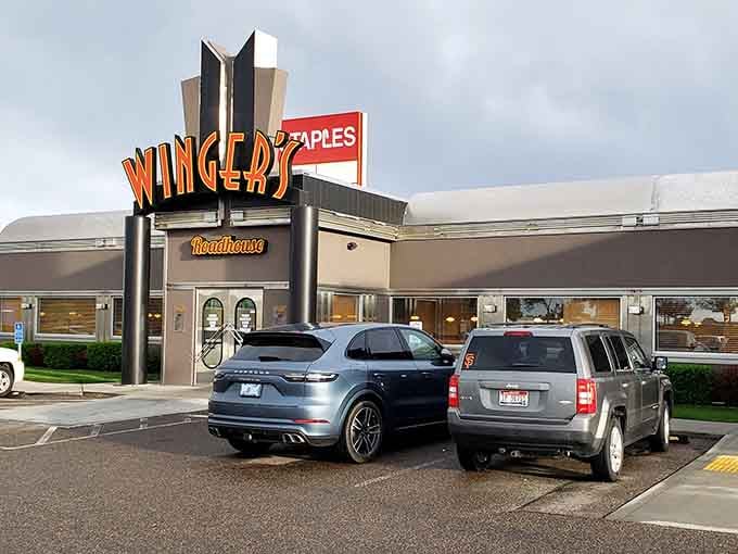 That retro neon sign beckons hungry travelers with promises of comfort food, because some cravings transcend state lines.