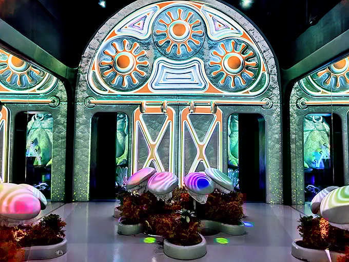 Mushroom sculptures glow beneath ornate arches, blending Alice in Wonderland with ancient temple vibes perfectly.