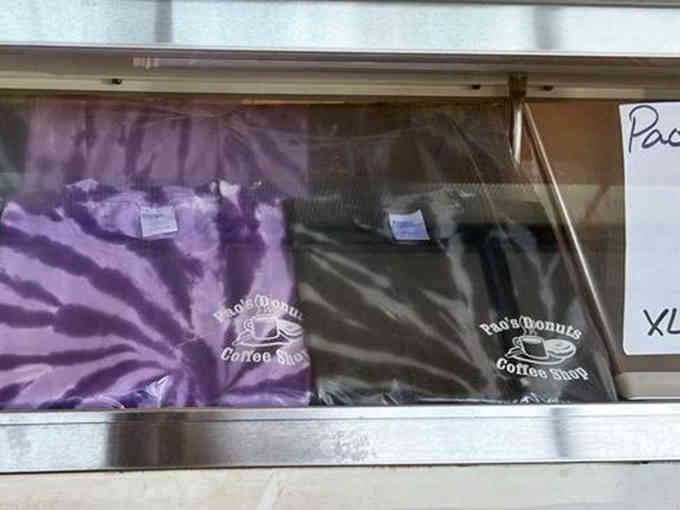 Local pride on display: grab a shirt to commemorate your pilgrimage to this beloved donut destination.