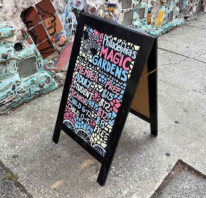 The sandwich board's playful typography matches the whimsical spirit inside, where serious art meets joyful creative chaos perfectly.