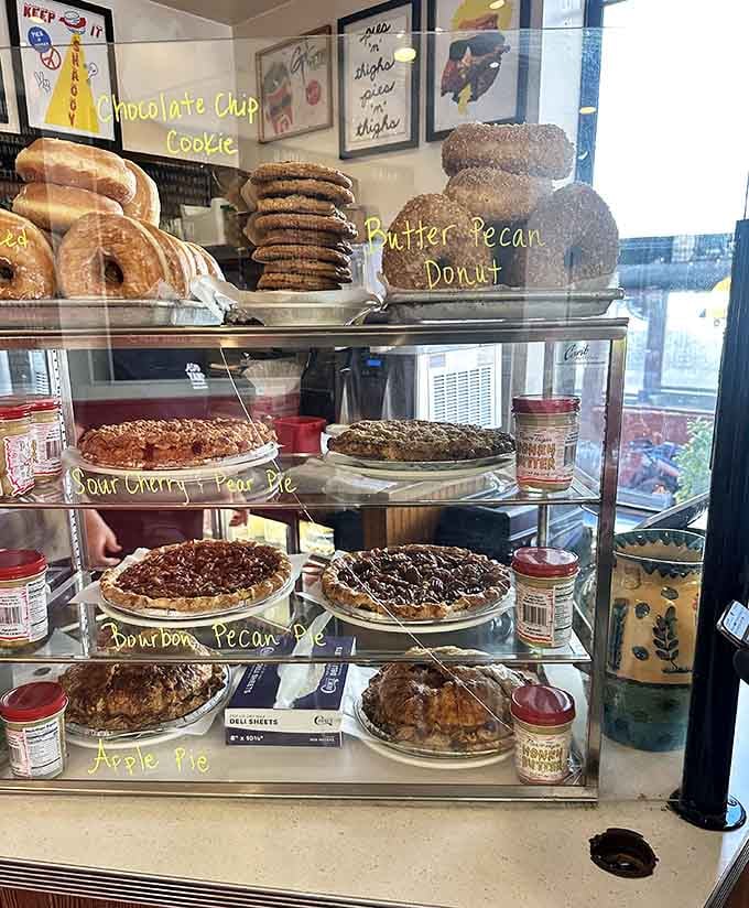 Stacked pies behind glass tempt you like sirens calling sailors, each one promising sweet redemption after all that savory glory.