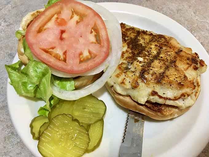 Grilled chicken on a bun with all the fixings, looking like it just stepped out of a diner dream sequence.