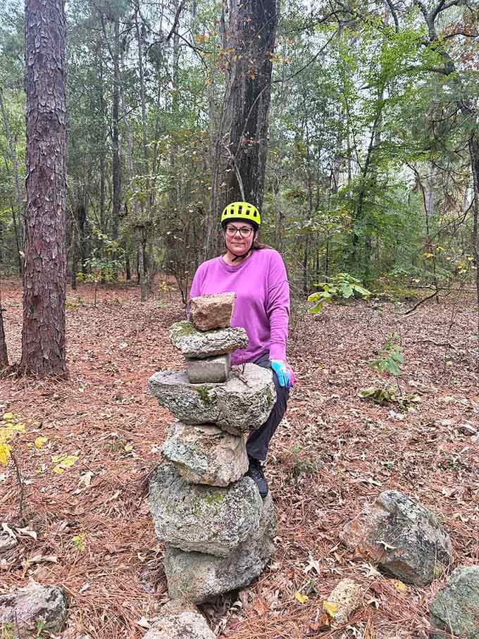 Trail markers and rock cairns guide adventurers through terrain that shifts from sandy ridges to shaded bottomlands.