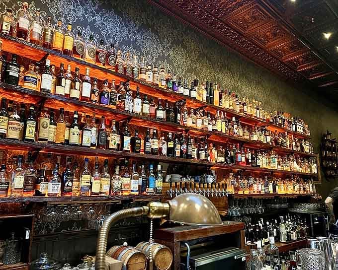 Behind the bar lies liquid happiness in bottle form, ready to complement whatever pizza masterpiece you order.