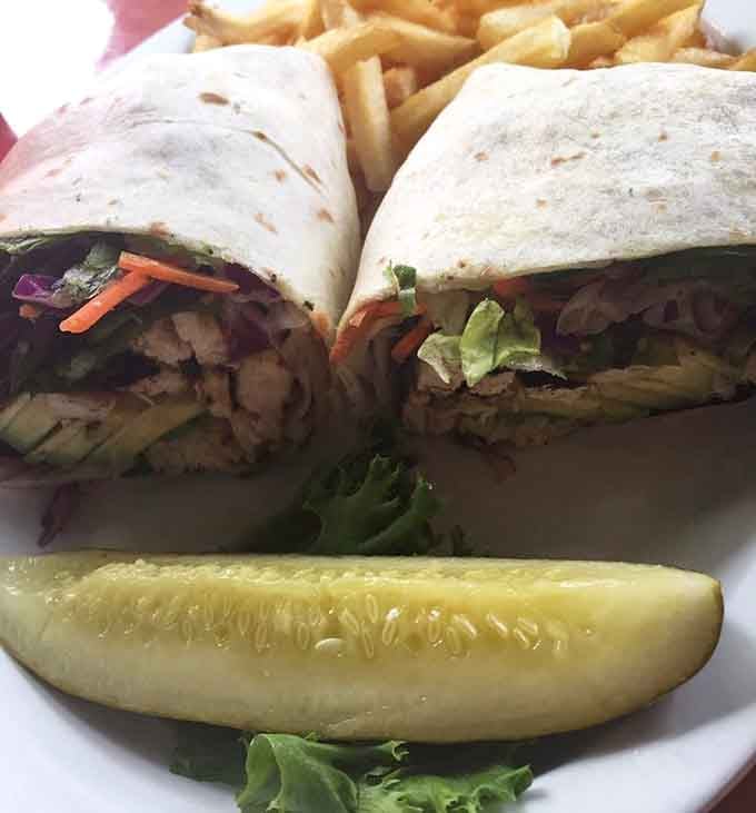 Turkey avocado wrap cut perfectly in half reveals layers of fresh ingredients, making healthy eating look almost as good as it tastes.