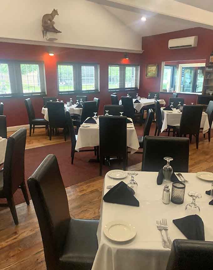 Another angle reveals the spacious dining room with decorative touches like that charming fox sculpture watching over diners below.