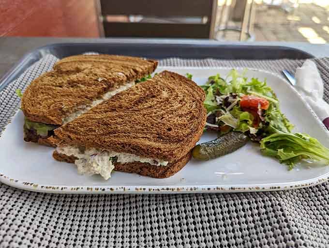 Grilled panini with fresh greens on the side shows the deli's commitment to balanced meals, even when cheese stars.