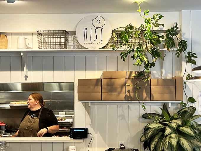 The friendly face behind the counter ready to guide you through donut decisions with patience and zero judgment whatsoever.
