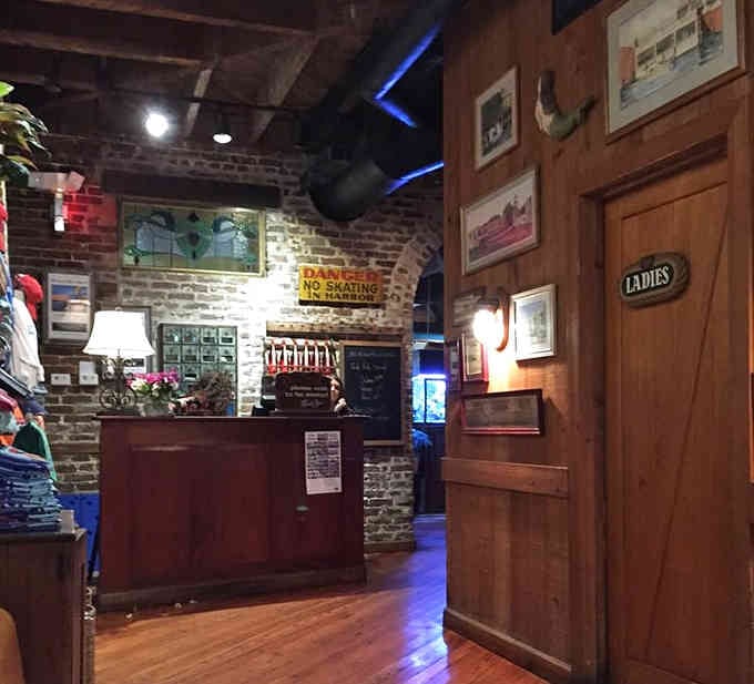 The host stand welcomes you with brick walls and vintage signs, setting the coastal vibe before you even sit down.