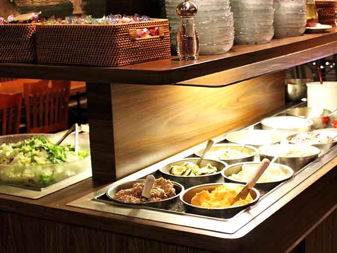 The salad station offers fresh options to balance out your steak, though let's be honest about what you came for.
