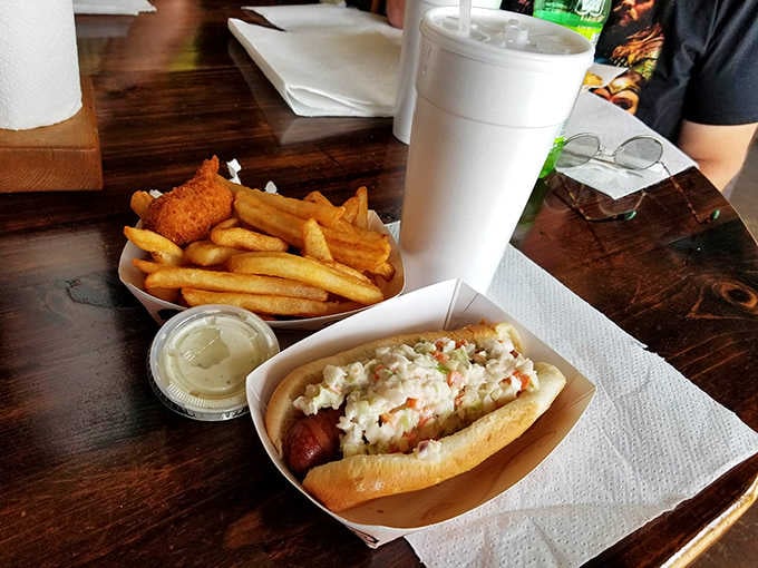 A hot dog topped with coleslaw proves that sometimes the simplest combinations create the most satisfying meals around.