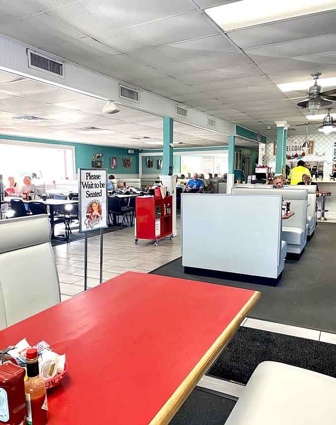 Sunlight streams through windows onto diners enjoying their meals in this welcoming, unpretentious space.