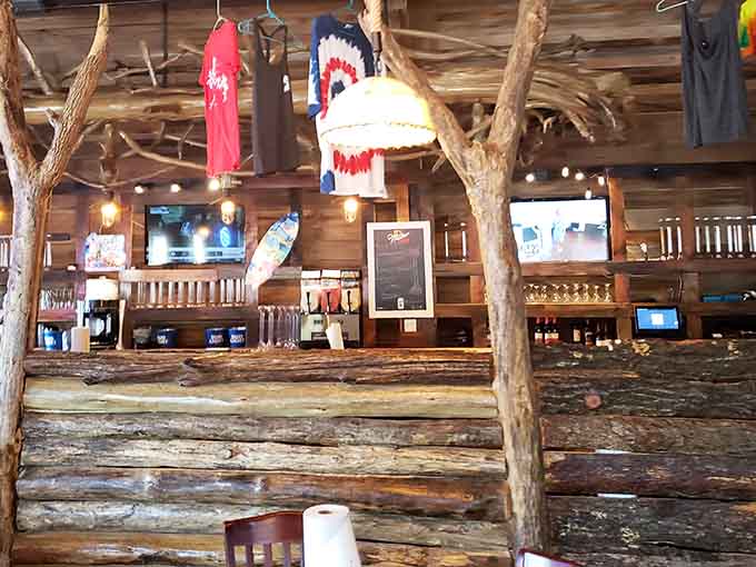 That handcrafted bar adorned with colorful fishing lures and lake memorabilia serves cold drinks with a side of authentic character.