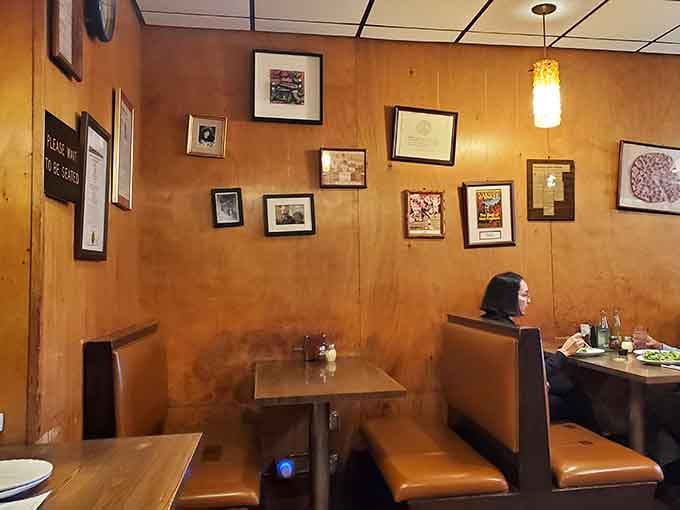 Every booth offers a front-row seat to watching pizza perfection emerge from that legendary oven.