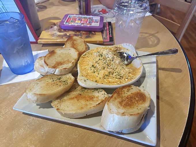 Bubbling hot seafood dip with toasted bread soldiers standing at attention, ready for their delicious duty.