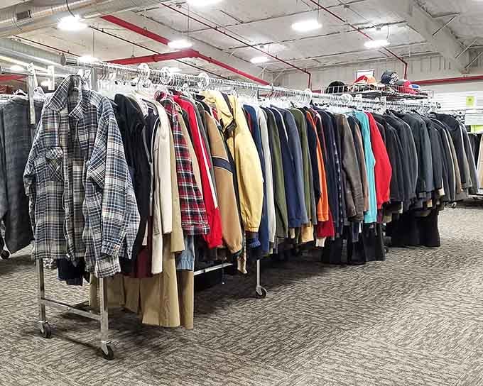 Rows of coats organized by color prove that secondhand doesn't have to mean second-rate shopping experiences at all.