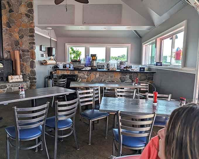 Stone accents and water views create a dining room where every seat feels like the good seat.