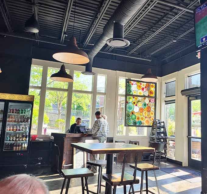 Industrial chic meets neighborhood comfort in a space where exposed ceilings and natural light create the perfect barbecue backdrop.