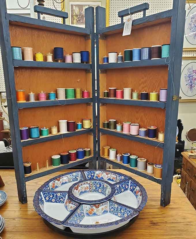 Vintage thread spools arranged like tiny soldiers, ready to mend clothes back when people actually fixed things instead of replacing them.