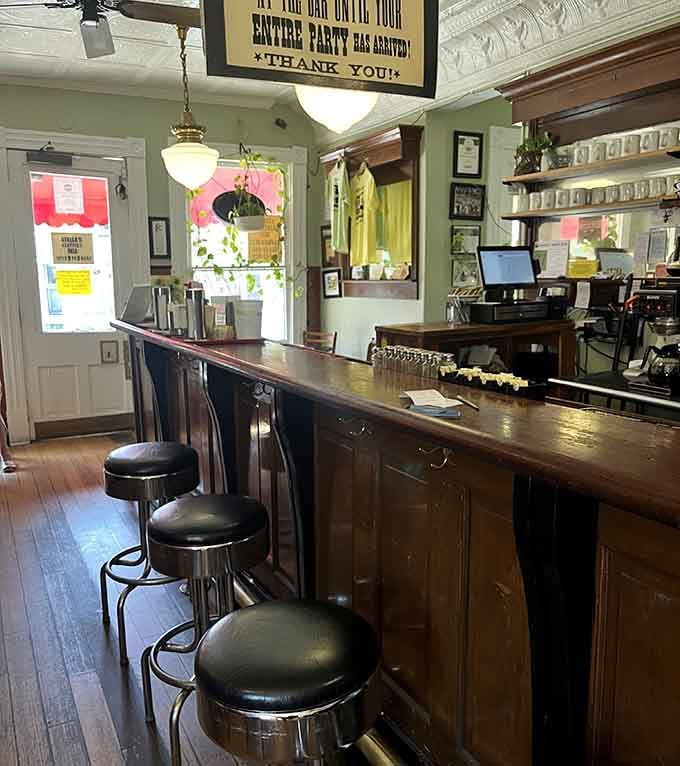 Bar seating with vintage stools offers front-row views of the action, perfect for solo diners or friendly conversation starters.