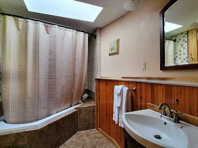 Even the bathrooms manage to balance rustic character with contemporary amenities, proving old and new can coexist beautifully.