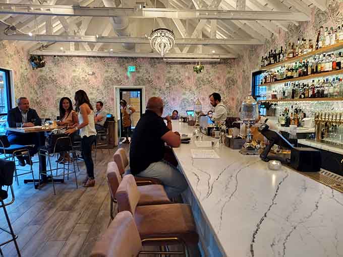 The marble bar and exposed brick walls create a sophisticated backdrop for conversations between your multiple dessert trips.