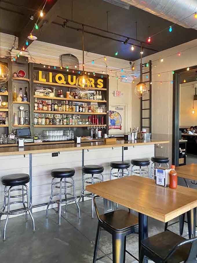 The bar area features a vintage "LIQUORS" sign reminding you this space has stories from multiple delicious eras.