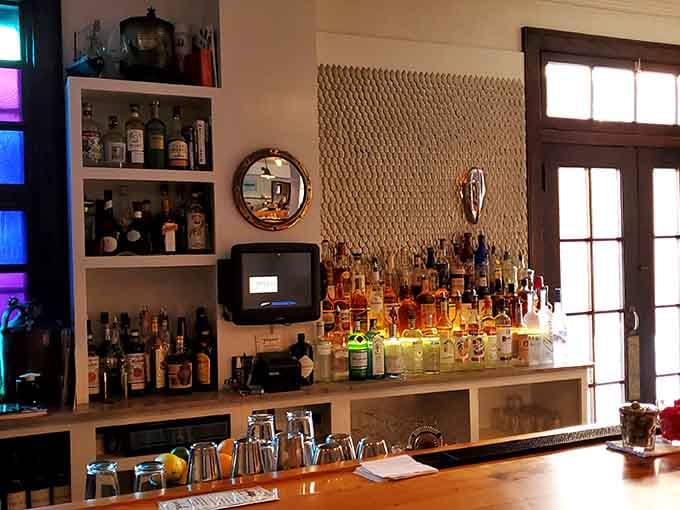 The bar area showcases an impressive spirits collection with nautical touches, ready to mix drinks that complement your seafood perfectly.