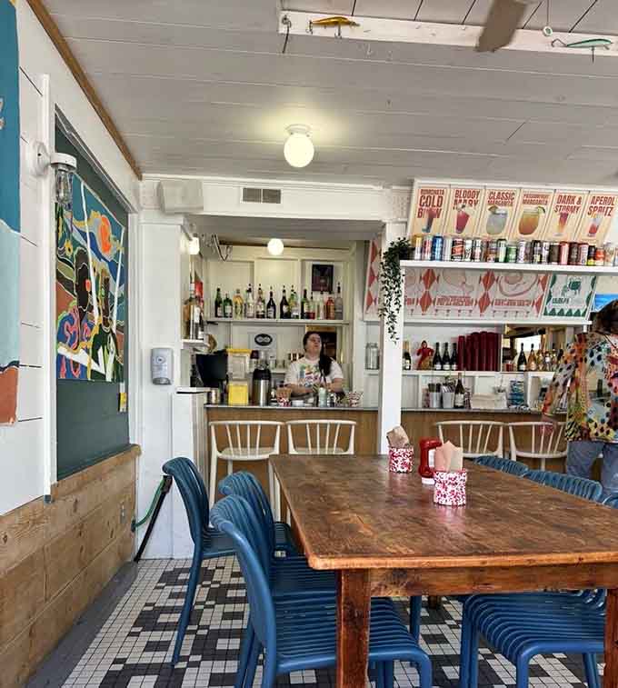 More cozy dining space where the checkered floor and communal tables invite you to settle in and stay awhile.
