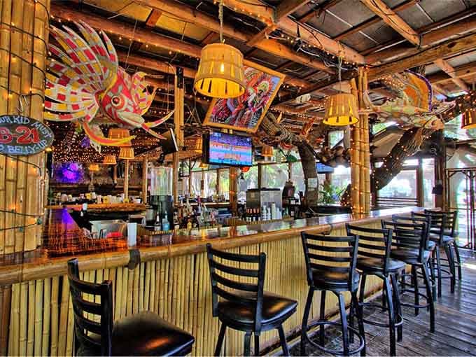 The bar area features colorful kites overhead, proving that whimsy pairs perfectly with a cold beverage.