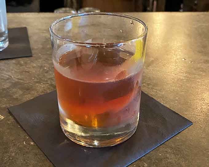 A perfectly crafted Manhattan with a sphere ice cube means someone here takes their cocktails very seriously.