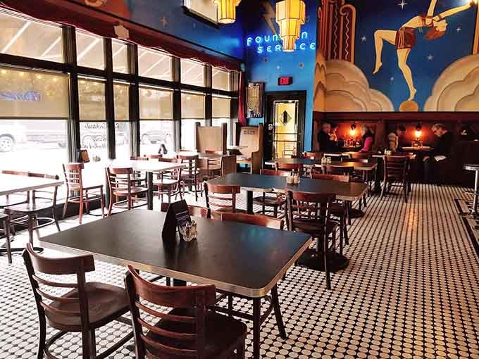 The dining area sprawls beneath those famous murals, offering plenty of space to settle in and stay awhile.