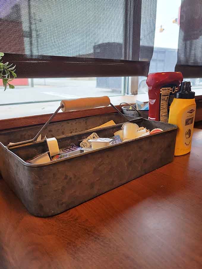 Condiments arrive in a vintage toolbox because even the ketchup deserves to feel like part of aviation history.